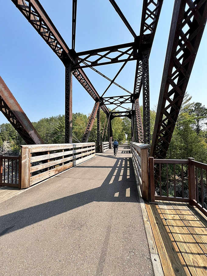 This historic iron bridge carries cyclists over rushing waters, combining engineering prowess with views that no smartphone camera can truly capture.
