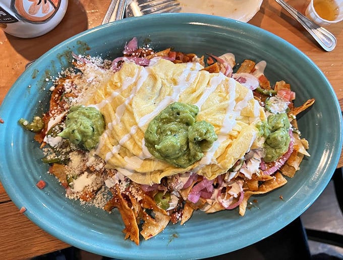 Crispy tortilla chips swimming in sauce, topped with eggs and guacamole&mdash;like nachos and breakfast had a beautiful, delicious baby.