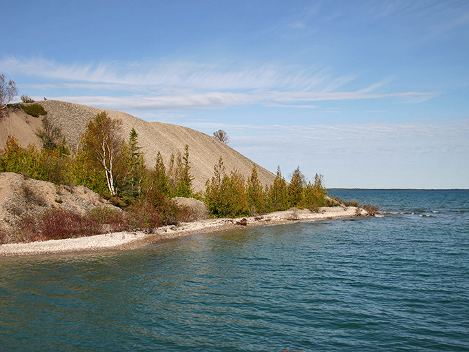 The dramatic hillside rises from the shoreline like a misplaced desert dune, creating a landscape that feels otherworldly.