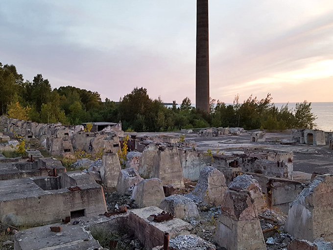 Geometric ghosts of foundation blocks create an industrial chessboard where nature and decay play their patient, endless game.
