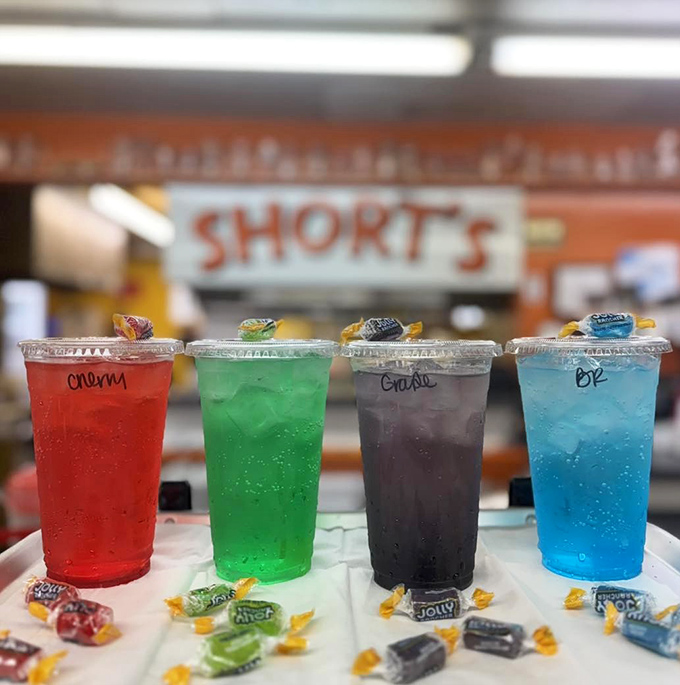Colorful candy-infused sodas that turn tongues the same shade as the drinks, childhood joy served in clear plastic cups.