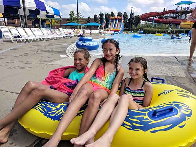 Three friends share an inner tube and smiles, creating the kind of carefree summer memories that'll last long after the chlorine smell fades.