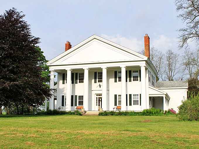 Gordon Hall stands as a Greek Revival testament to 1840s architectural ambition, its white columns reaching skyward like a Southern mansion transplanted north.