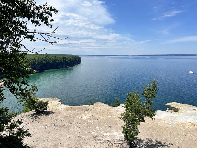 Grand Portal Point showcases nature's patient artistry, where centuries of waves have sculpted stone into a masterpiece of curves and colors.