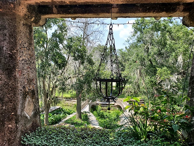 An antique lantern frames the view of garden bridges below, offering a glimpse into the property's thoughtful, layered design.