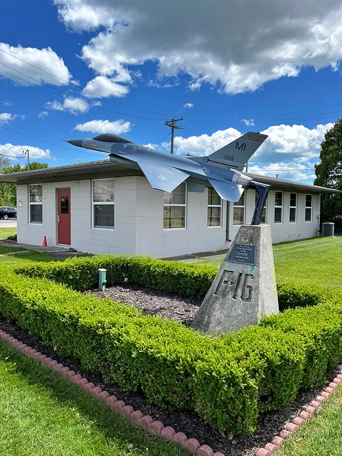 This F-16 memorial stands as a sleek sentinel outside the museum entrance, its aerodynamic silhouette cutting through Michigan skies even while stationary.