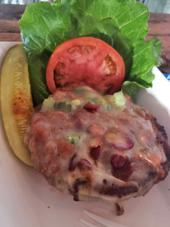 Bean-studded burger bliss! This juicy patty topped with melty cheese and fresh veggies is the vacation your taste buds have been saving up for.