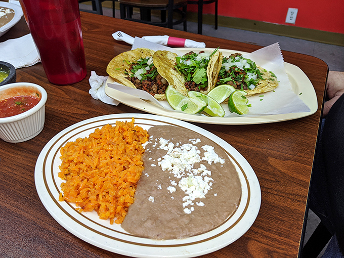 Tacos served simply with cilantro, onions, and lime, letting the quality meat do all the talking it needs.