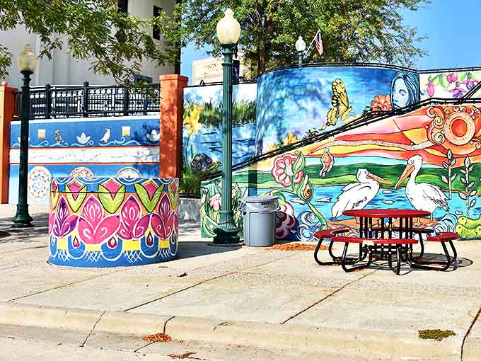 Colorful murals and matching street furniture create inviting public spaces where visitors can rest between treasure hunts through the town's antique shops.