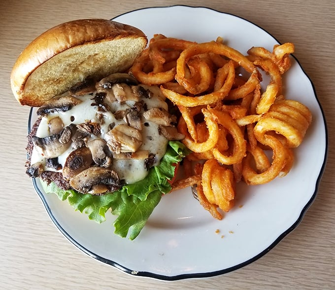 This mushroom Swiss burger arrives with curly fries that seem to defy gravity&mdash;lunch for champions after conquering breakfast.
