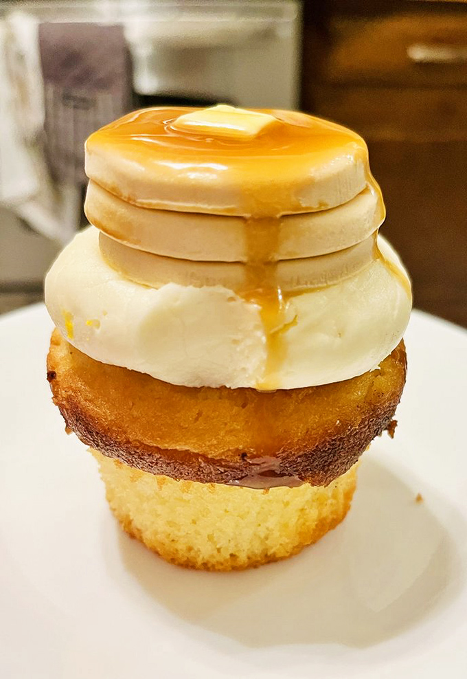 Breakfast or dessert? This pancake cupcake boldly asks, "Why choose?" as maple syrup cascades down buttery layers of morning-meets-afternoon indulgence.