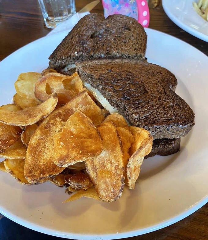 This patty melt doesn't just satisfy hunger—it abolishes it completely with toasty bread, melty cheese, and house-made chips.