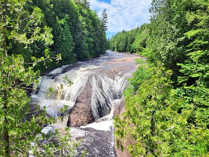 Summer's grand performance at the falls – when the water dances, the forest sings, and visitors become part of nature's standing ovation.