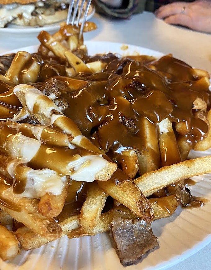 Poutine: French fries swimming in gravy and melted cheese &ndash; a heart-stopping indulgence that makes cardiologists wince and taste buds sing hallelujah.