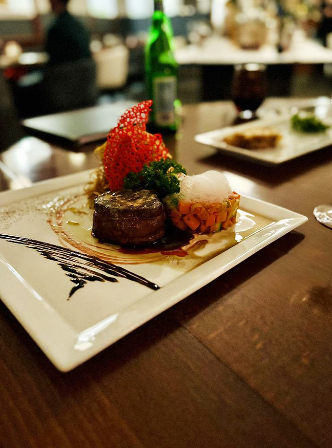 Prime Filet Mignon that's more tender than the last five minutes of a rom-com, adorned with a dramatic red tuile that deserves its own spotlight.