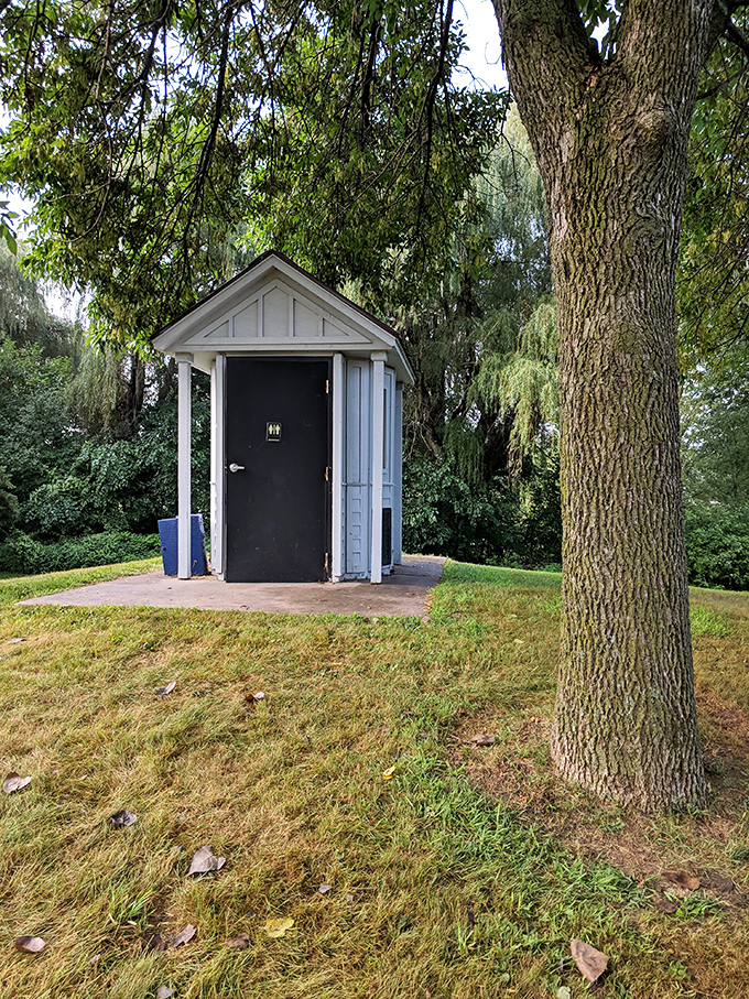 Even the restroom gets the whimsical treatment, housed in a charming white structure that looks more like a fairy tale cottage than a facility.