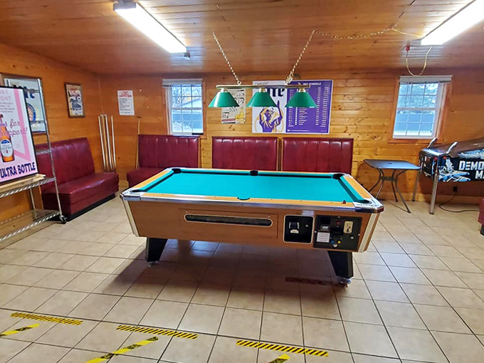The classic northwoods interior features knotty pine walls that have absorbed decades of stories, laughter, and the occasional fishing tale. 