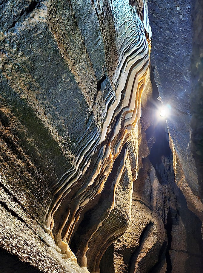 Rock formations hang like nature's chandeliers, their mineral compositions creating subtle variations in color and texture.