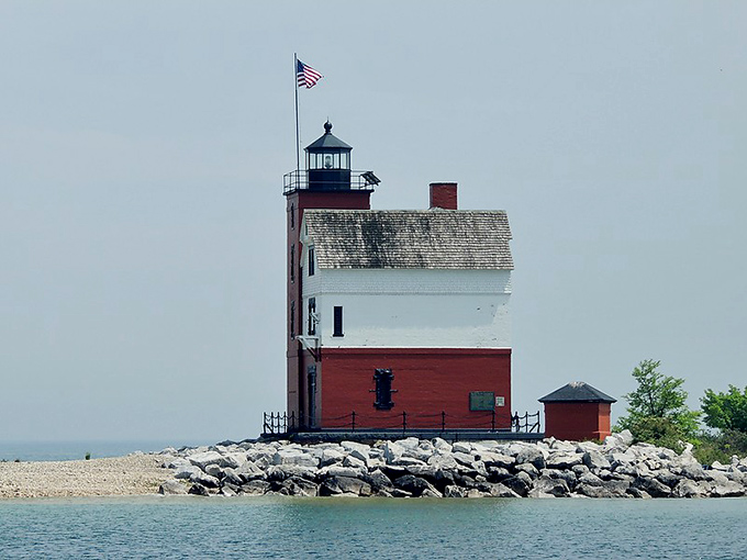 The side view reveals the lighthouse's true character &ndash; part functional beacon, part architectural showoff with that perfect red-and-white color scheme.