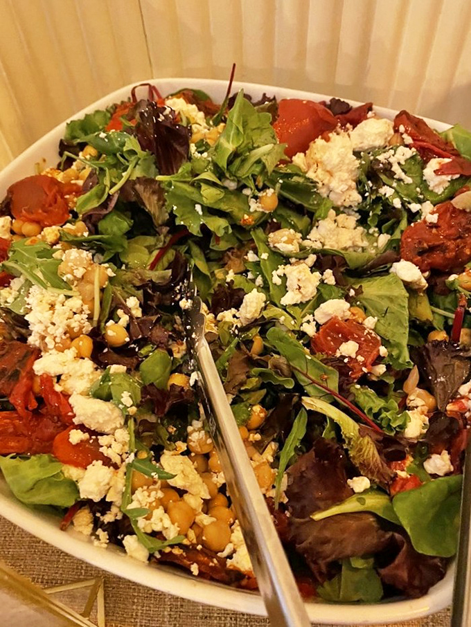 Fresh greens, roasted tomatoes, and crumbled cheese create a colorful counterpoint to all those carbs, proving vegetables can hang with the cool kids.