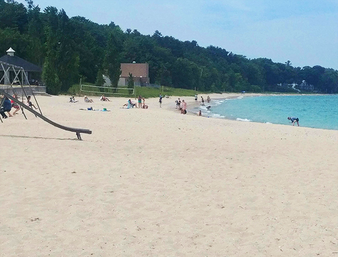 Simple pleasures: where pristine sand meets refreshing waters, creating the perfect playground for memory-making at Michigan Beach Park.