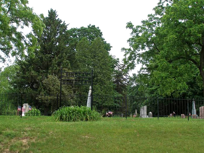 Summer's greenery softens the cemetery's somber purpose, though some visitors report cold spots even on the warmest days.