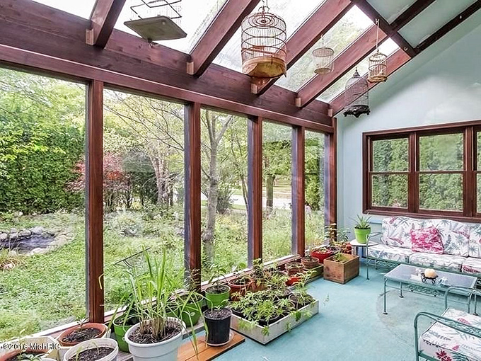 Glass-enclosed sanctuary where plants thrive and humans remember what relaxation felt like before smartphones existed.