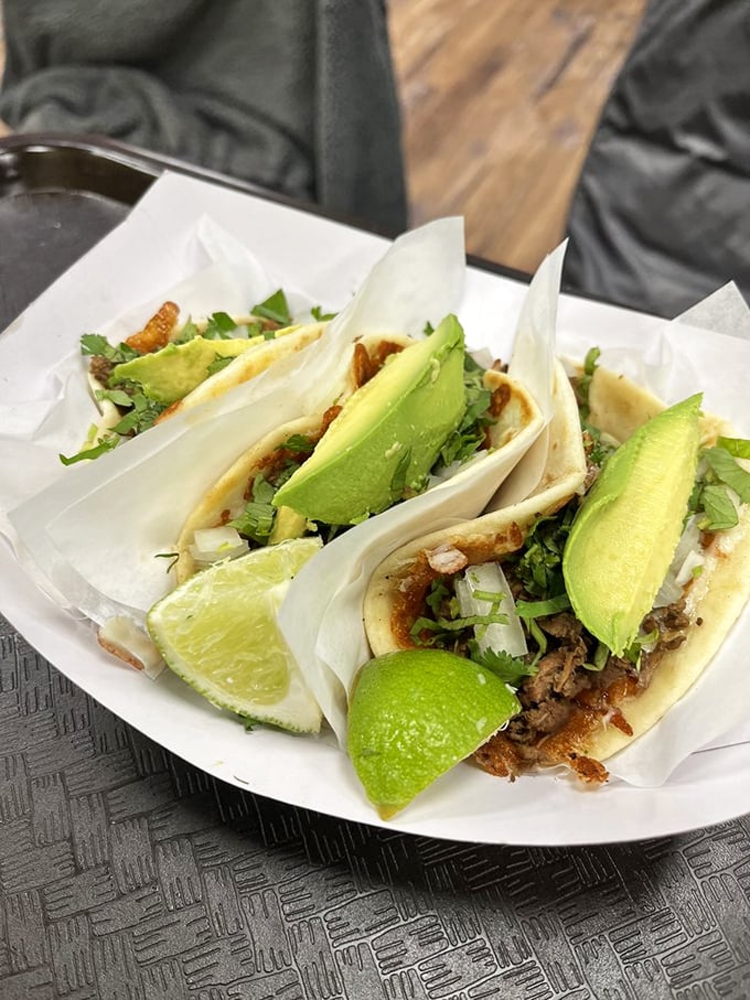 Street tacos done right – handmade corn tortillas cradle perfectly seasoned meat, topped with fresh cilantro, onion and lime wedges.