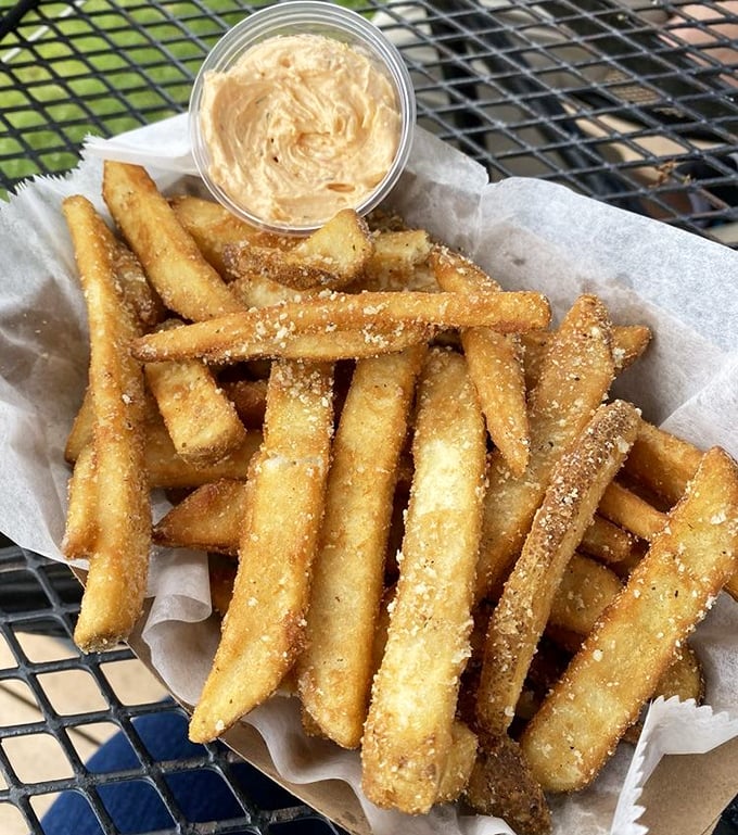 These aren't ordinary fries &ndash; they're truffle-dusted potato perfection with pimiento cheese dip that'll have you scraping the container clean.