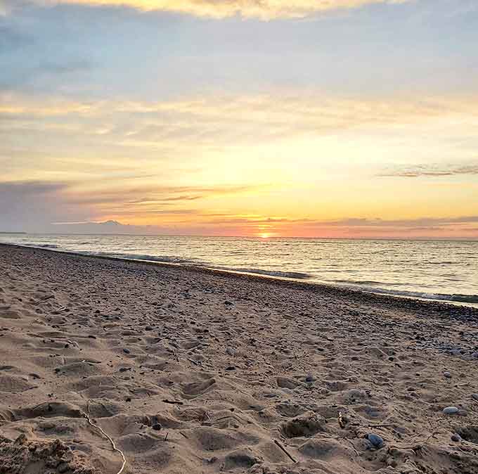 Sunset transforms Lake Superior into liquid gold, painting the kind of horizon that makes smartphones feel utterly inadequate.