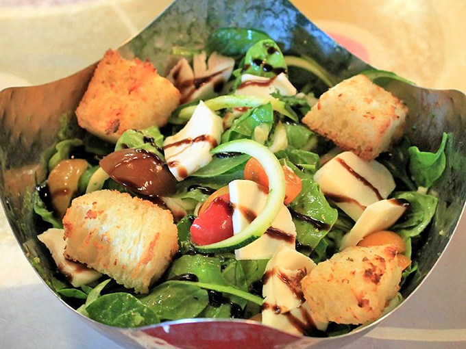 This isn't just a side salad &ndash; it's a thoughtfully composed dish with crisp greens, zucchini ribbons, and perfectly toasted croutons.