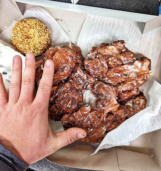 The legendary apple fritter – crispy, caramelized edges giving way to tender, apple-studded interior. Worth every delicious calorie.