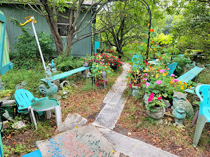 The garden path winds through a turquoise wonderland, where even the outdoor space continues the playful theme with colorful seating and whimsical decorations.