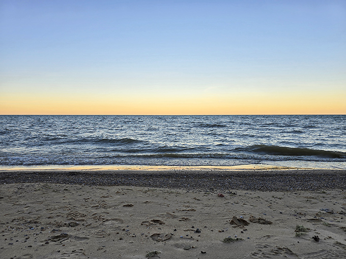 Twilight softens the shoreline into watercolor perfection, as the day's final light bathes everything in a gentle, rosy glow.