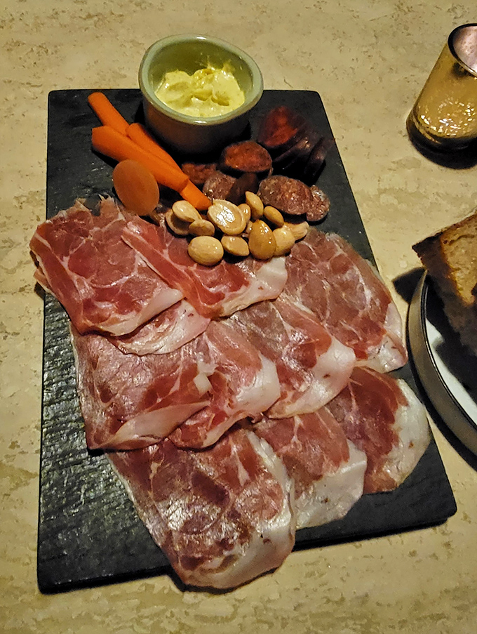 A charcuterie board that tells a story of craftsmanship, with each paper-thin slice of meat arranged with an artist's attention to detail.