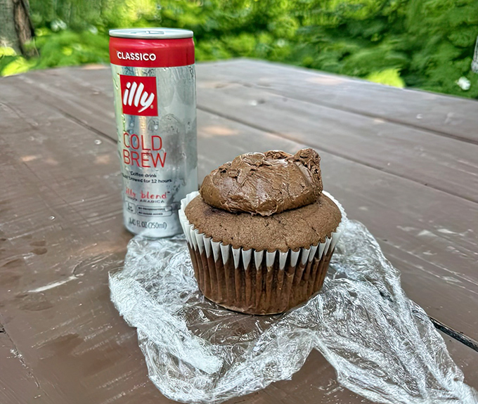 A perfect pairing: a chocolate cupcake with a cold brew creates an impromptu communion with nature on the bakery's rustic outdoor seating.