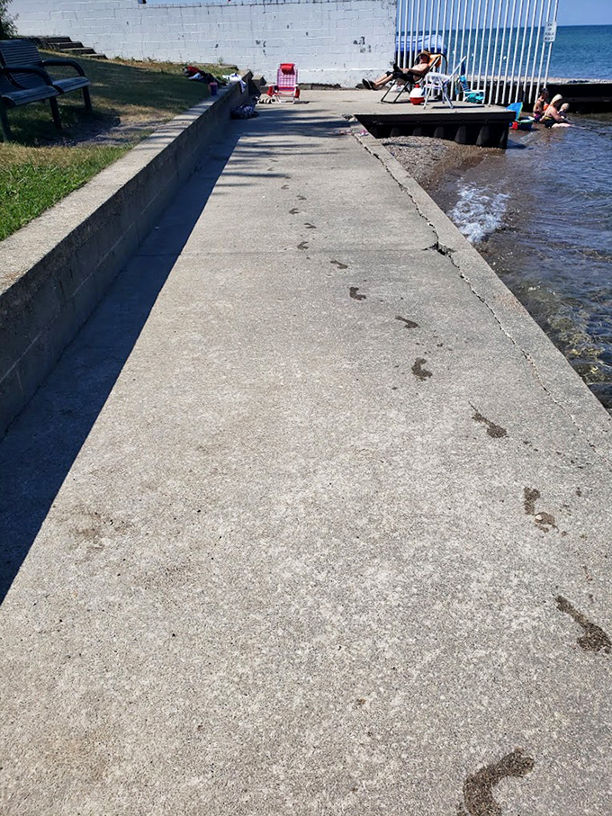 Footprints tell stories of beach adventures along this well-worn path, where generations have made their way to Lake Huron's refreshing waters.
