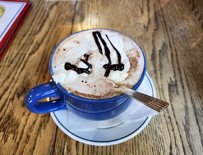 Nothing pairs better with Michigan winters than this hot chocolate, served in a blue ceramic mug with whipped cream and chocolate drizzle.