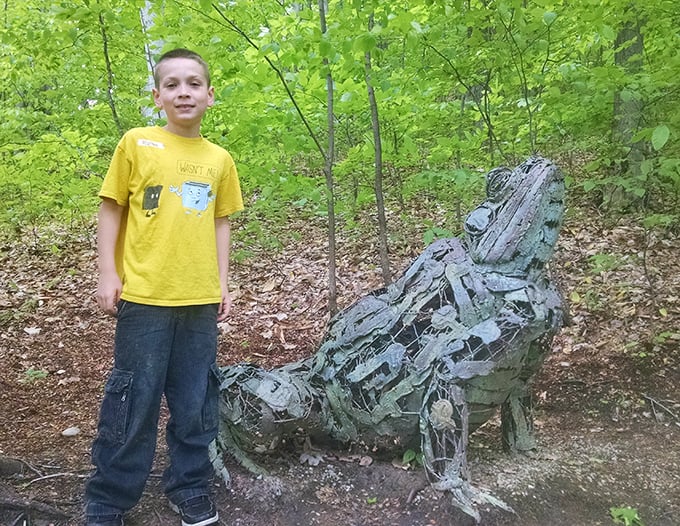 A young explorer stands beside a glass-like sculpture, demonstrating how the park sparks curiosity and engagement across generations.