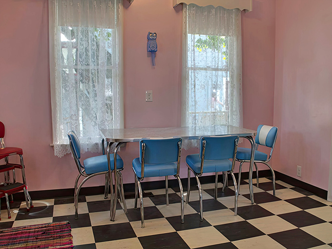 Candy-pink walls and chrome accents create a breakfast nook straight out of an Edward Hopper painting with happier colors.