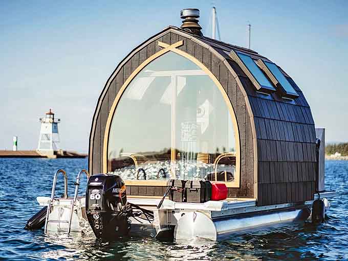 Sunset paints the water gold through the sauna's picture window, transforming an ordinary evening into a moment of extraordinary beauty.