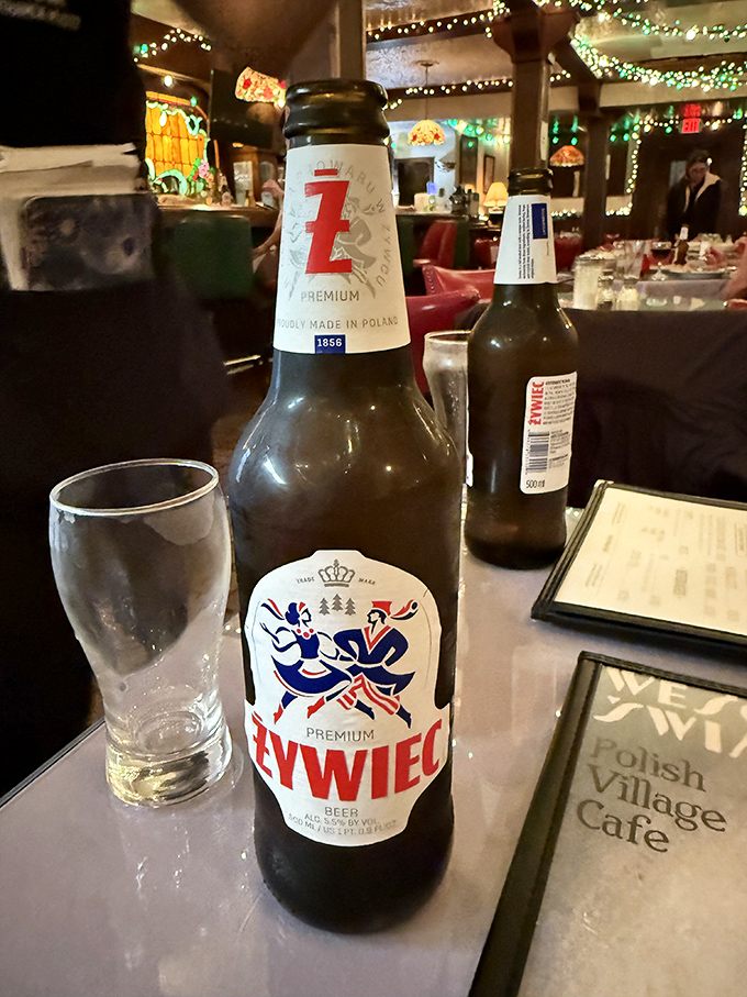 A bottle of Żywiec stands ready to complement your meal &ndash; this classic Polish lager cuts through rich flavors with refreshing crispness that's been perfected since 1856.