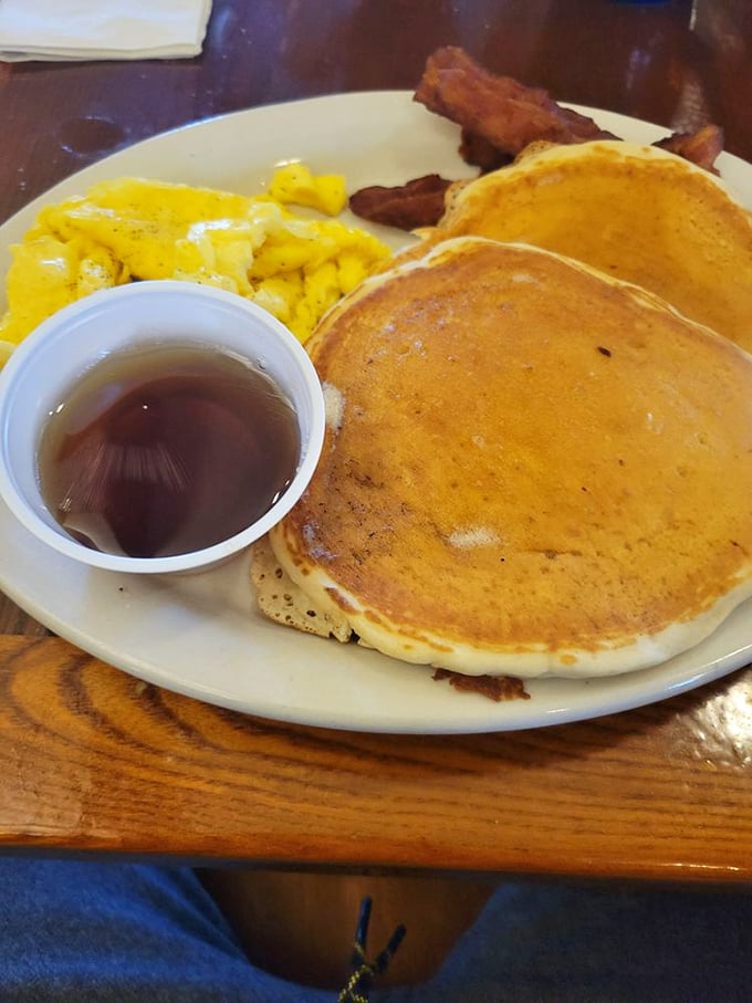Pancakes so perfectly golden they could win medals, with maple syrup waiting patiently to create breakfast magic.