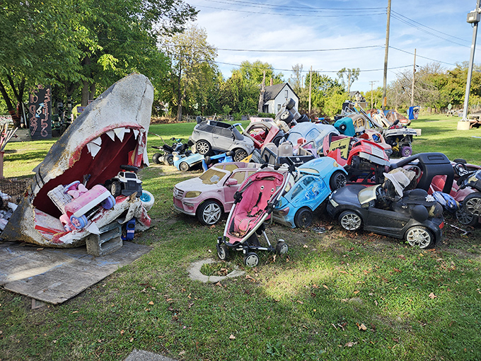 Toy cars create a traffic jam of childhood nostalgia, parked permanently in artistic rebellion against Detroit's automotive legacy.