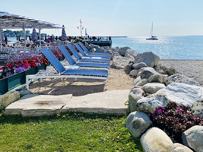 Beach loungers await sun-seekers along the rocky shoreline, promising front-row seats to Lake Huron's ever-changing blue canvas.