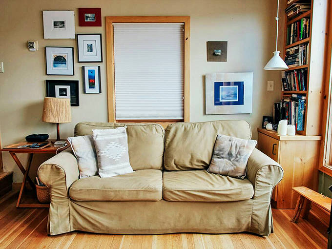 This inviting sofa practically whispers, "Come, sit awhile and watch the lake dance through those windows."