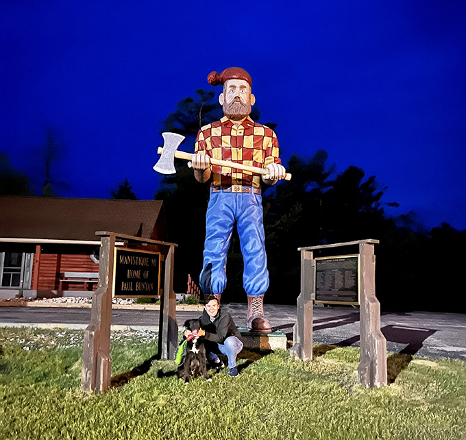 As darkness falls, Paul maintains his vigilant watch over Manistique, his silhouette dramatic against the deepening blue of evening.