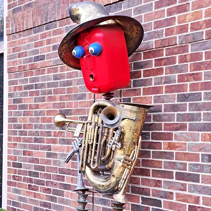 This musical robot seems ready to strike up the band, its brass body a symphony of repurposed instruments.