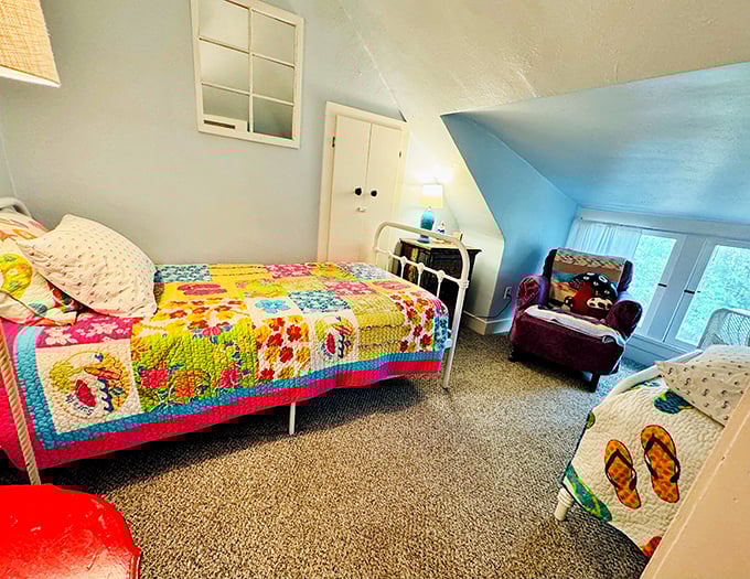 Upstairs dreams await in this cheerful bedroom where colorful quilts add whimsy to the already enchanting atmosphere.