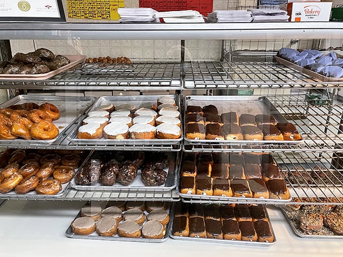 The display case offers a museum-worthy collection of pastry perfection – each tray a different expression of the baker's time-honored craft.
